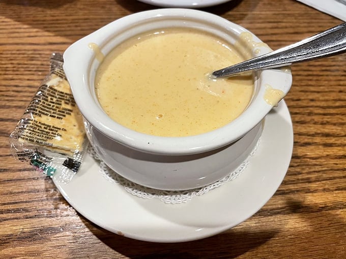 The legendary lobster bisque arrives in its porcelain throne, a velvety kingdom where cream and lobster live in perfect harmony.