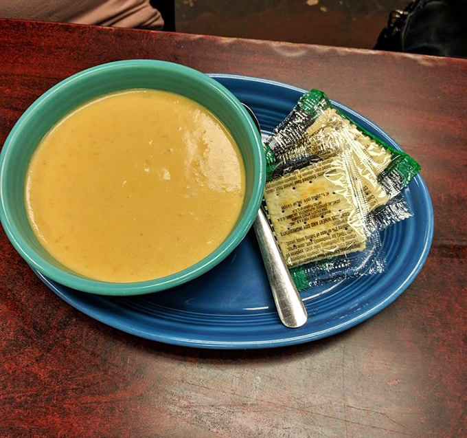 A bowl of golden promise with crackers standing by. Soup this good deserves a moment of silent appreciation.