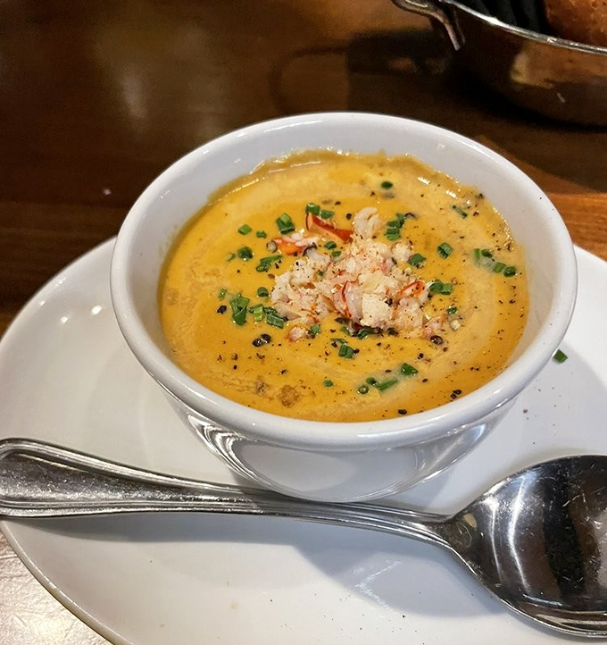 The lobster bisque arrives like liquid velvet in a bowl, topped with delicate chunks of lobster meat and fresh herbs&mdash;soup that demands to be savored, not just eaten. 