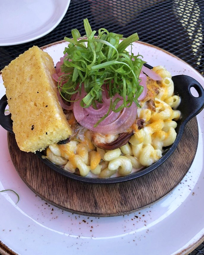 Mac and cheese elevated to an art form&mdash;complete with cornbread sidekick and pickled onions that cut through the richness like witty banter.