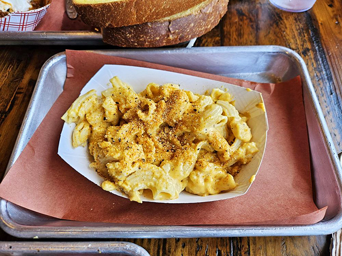 Mac and cheese that achieves the impossible: creamy yet structured, with a golden top that makes you want to break through like a cr&egrave;me br&ucirc;l&eacute;e.