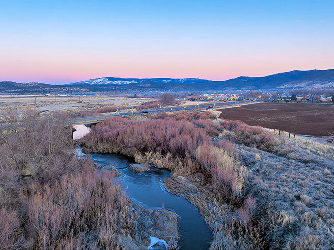 The Susan River at dusk paints the landscape in watercolor hues of pink and purple, a daily masterpiece that no gallery could ever contain.