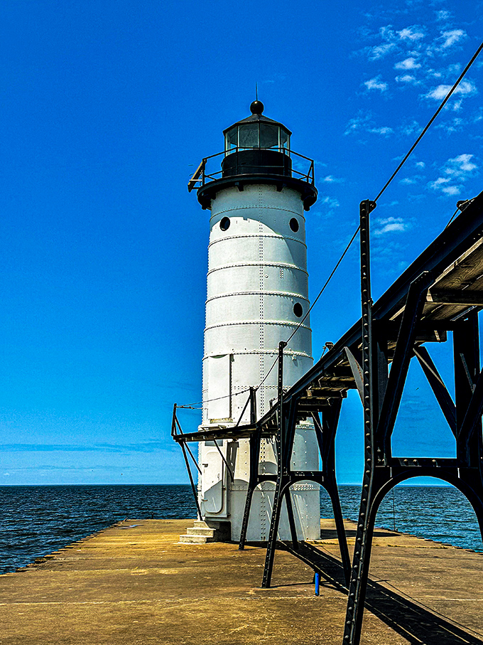 Manistee's North Pier Lighthouse stands sentinel where river meets lake, a gleaming white beacon that's been Instagram-worthy since long before Instagram.
