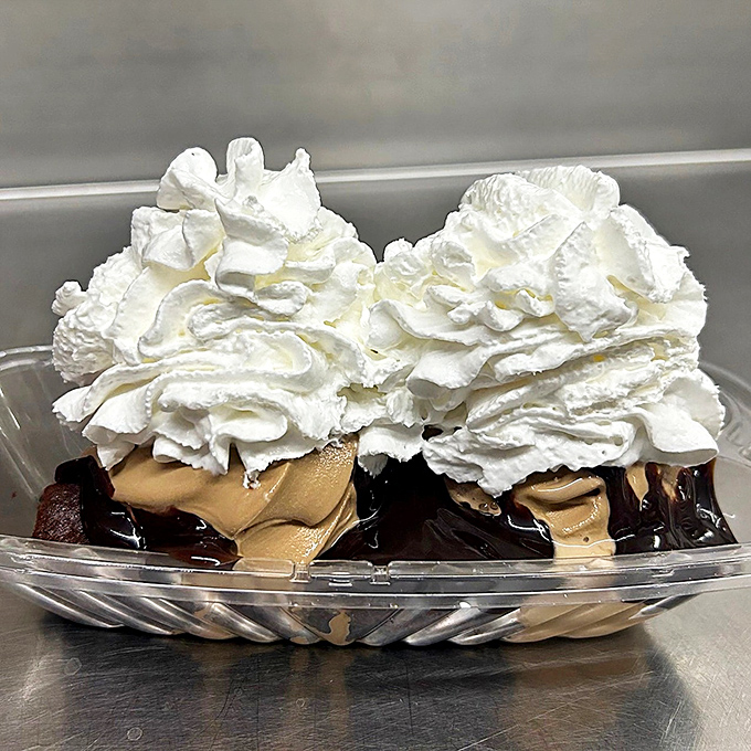 This hot fudge sundae isn't just dessert, it's architecture &ndash; towering whipped cream atop rivers of fudge and creamy ice cream below.