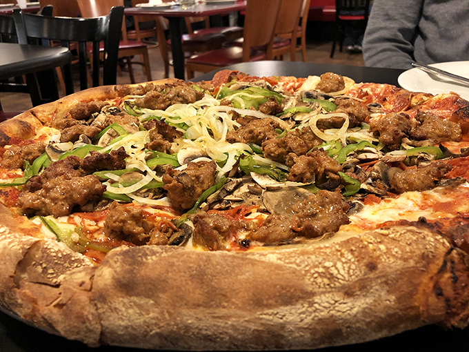 That sausage-topped masterpiece with its golden crust is the kind of pizza that ruins you for all other pizzas.