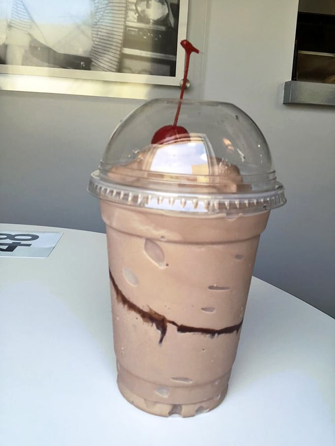 The chocolate milkshake arrives like a cool, creamy tower of indulgence&mdash;that cherry on top isn't just garnish, it's a promise.