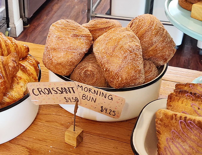 Morning buns displaying their spiral perfection like edible cinnamon roll sculptures demanding immediate attention and appreciation.