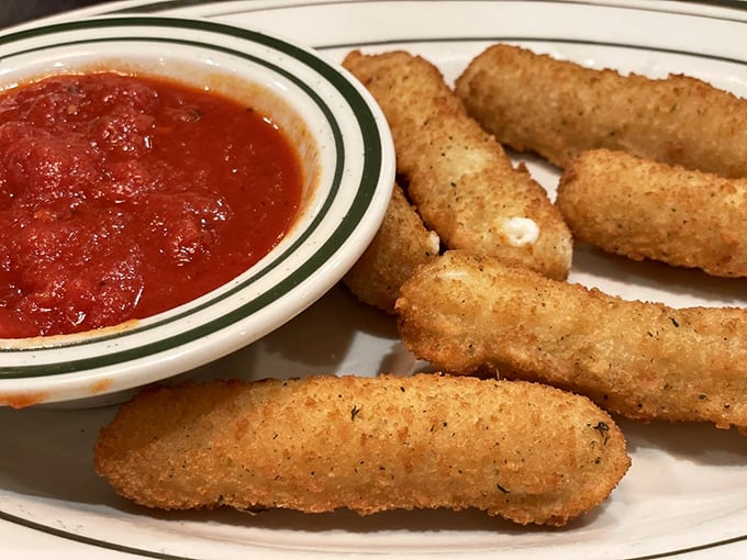 These aren't just mozzarella sticks—they're golden-armored cheese soldiers standing at attention beside a pool of marinara, awaiting your command.