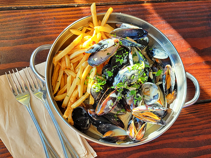 Mussels and fries: Belgium's gift to the world, reimagined oceanside. The empty shells become little scorecards of your delicious achievement.