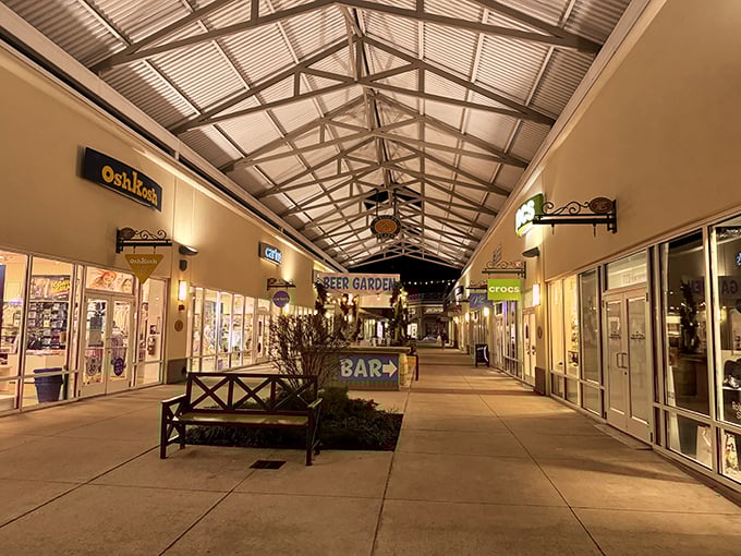 As night falls, the outlets transform into a twinkling shopping village. Even Crocs look sophisticated under evening lights.