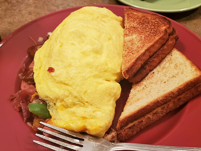This omelet doesn't just sit on the plate&mdash;it commands attention. Fluffy eggs embracing savory fillings with perfectly toasted bread standing guard.