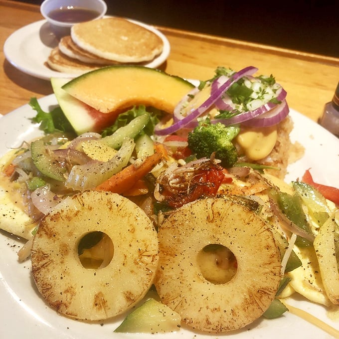 Breakfast artistry that makes ordinary omelets look like stick figures. Those grilled pineapple rings are like sunshine on a plate.