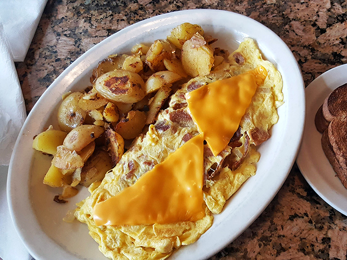 The cheese omelet that launched a thousand return visits. Paired with those home fries, it's the breakfast equivalent of finding a parking spot at the beach.