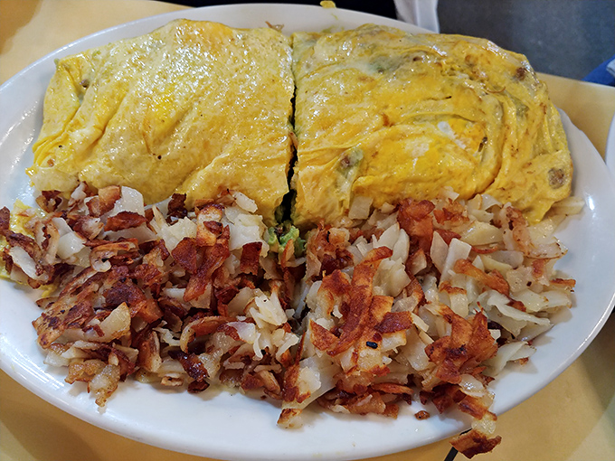 This isn't just an omelet&mdash;it's an architectural achievement. Paired with hash browns so perfectly crispy they deserve their own fan club.