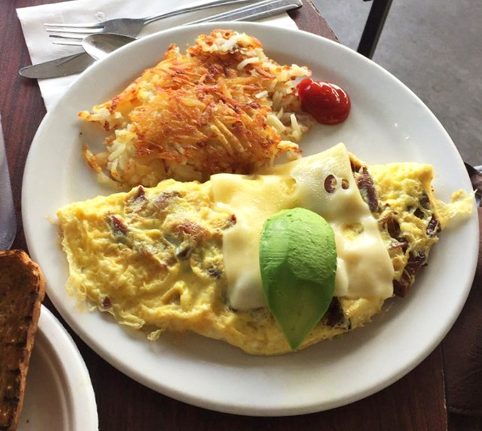 An omelet that doesn't need fancy French techniques&mdash;just cheese, perfectly crispy hash browns, and a slice of avocado playing king of the mountain.