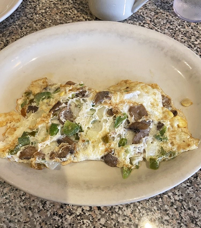 This omelette doesn't just contain mushrooms and peppers&mdash;it showcases them like treasured jewels in a fluffy egg crown.