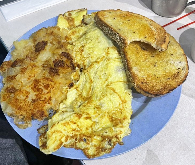 This isn't just an omelet&mdash;it's a fluffy yellow pillow of breakfast joy paired with those legendary Lyonnaise potatoes.
