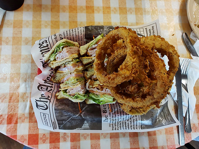 A club sandwich and onion rings served on newspaper&mdash;because good food is the only headline that matters in Centerville.
