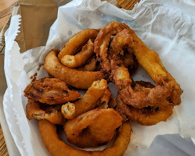 Golden halos of deep-fried perfection. These onion rings aren't just sides; they're the supporting actors that sometimes steal the show.