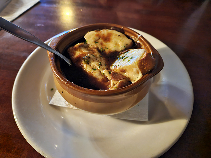 French onion soup that doesn't just warm your body but hugs your soul&mdash;a bubbling cauldron of comfort topped with golden, melted cheese.