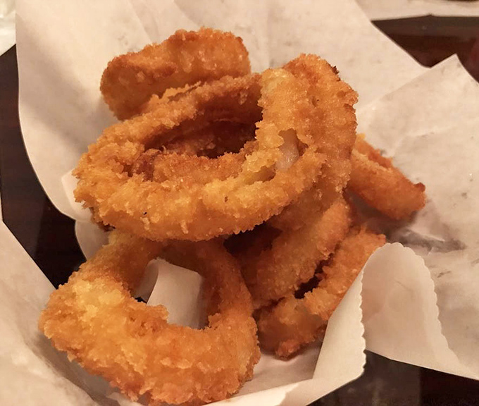 Golden-fried onion rings that shatter with each bite &ndash; the perfect supporting actor to the burger's leading role.