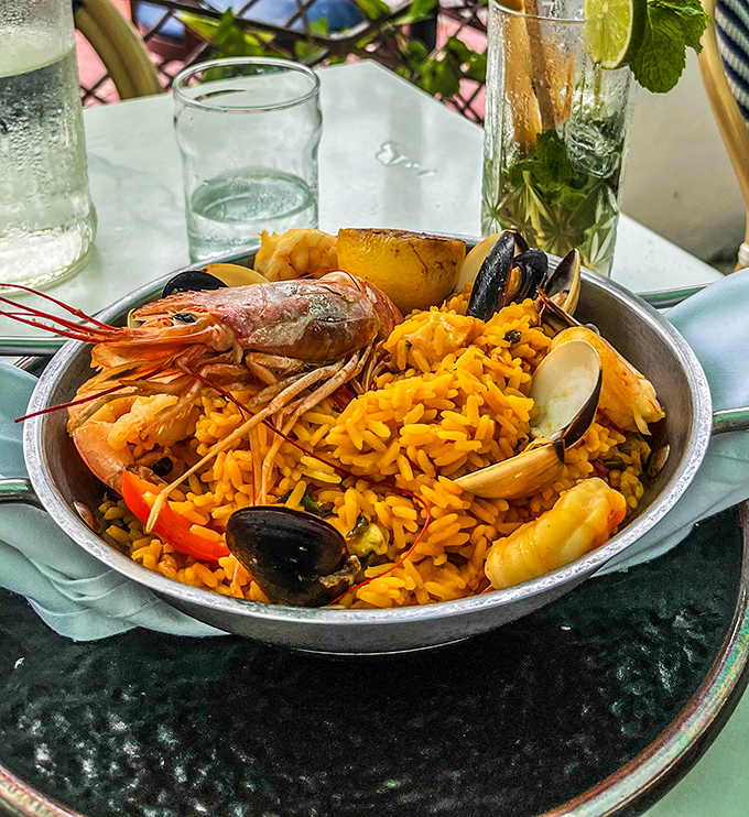 Paella that would make Valencia jealous, each grain of saffron rice telling its own delicious story.
