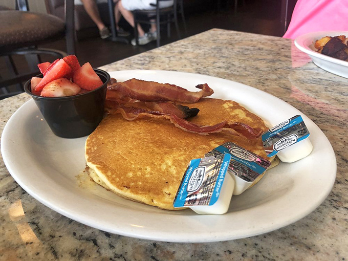Golden pancakes with the perfect sidekicks: crispy bacon and fresh strawberries. The breakfast equivalent of a superhero team-up.