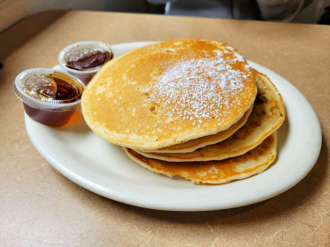Pancakes stacked higher than Silicon Valley rent prices, golden-brown and waiting patiently for their maple bath. Breakfast perfection exists.