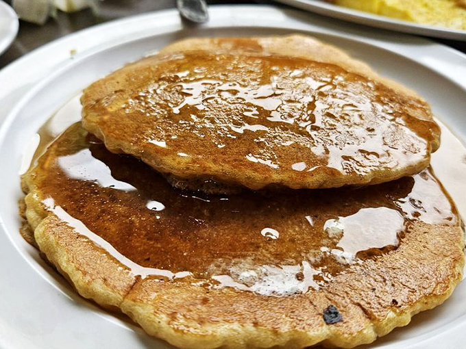 These pancakes aren't just round&mdash;they're perfect golden discs of happiness, glistening with maple syrup like morning sunshine after a rainstorm.