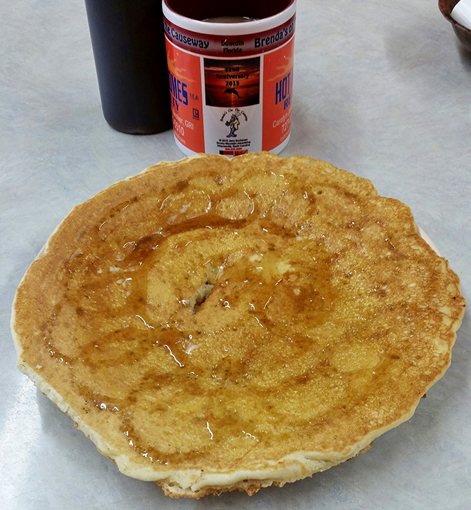 A pancake so perfectly golden it belongs in Fort Knox. Maple syrup pools in the center like nature intended.