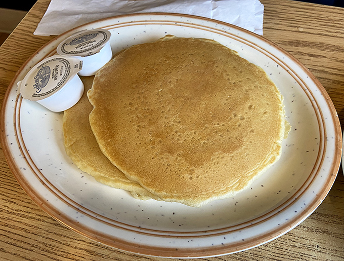 Pancakes so perfectly golden they belong in Fort Knox. Simple, unpretentious, and exactly what pancakes should be&mdash;a blank canvas for syrup rivers and butter lakes.