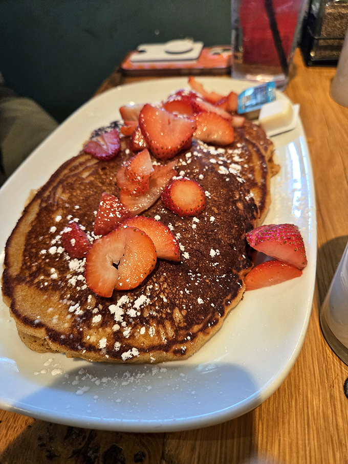 These aren't just pancakes&mdash;they're fluffy golden discs of joy, topped with fresh strawberries that somehow make you feel virtuous about eating dessert for breakfast.
