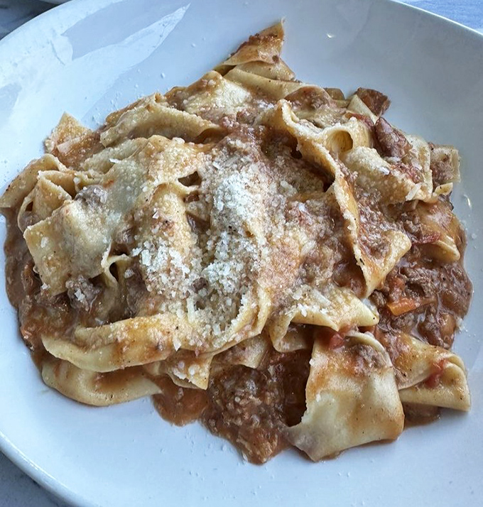 Wide ribbons of pasta embracing a hearty Bolognese that's clearly been simmering since before you made your reservation.