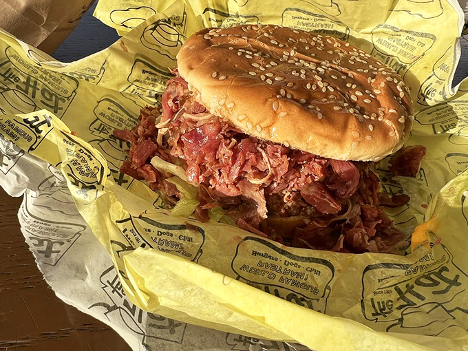 The pastrami burger - where two comfort food legends unite like Sinatra and Bennett. The sesame seed bun struggles heroically against its magnificent contents.