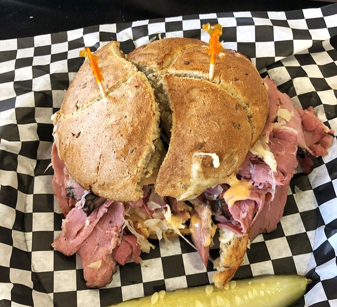 A pastrami sandwich so generous it requires structural engineering. The pickle on the side isn't garnish&mdash;it's necessary balance in a meat-centric universe.