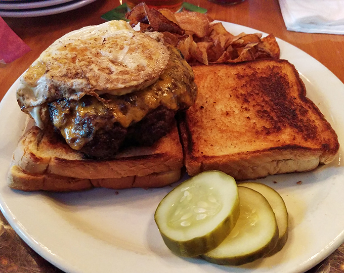 The burger that launched a thousand napkins. This towering creation makes you grateful for both gravity and elastic waistbands.
