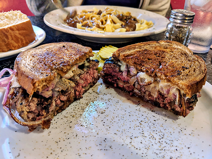 A patty melt cut in half to reveal its secrets. Like a good novel, the best sandwiches always have layers of complexity.