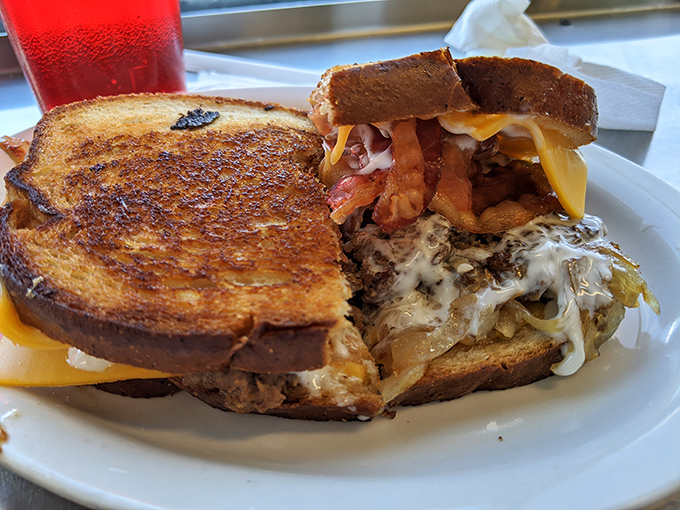 The patty melt: where grilled cheese meets burger in a beautiful marriage that would make any comfort food enthusiast weak in the knees.