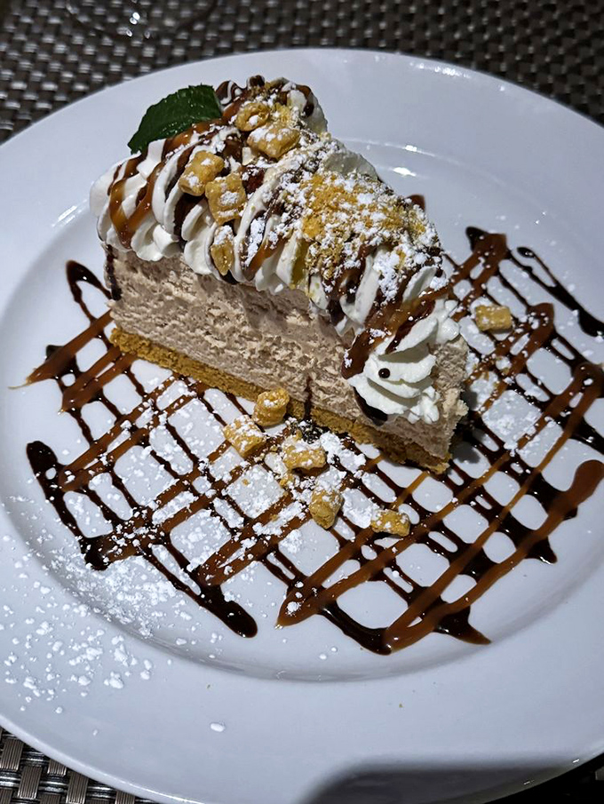 Not just dessert, but an architectural masterpiece of cream, chocolate, and what appears to be peanut butter&mdash;calories worth every delicious bite.