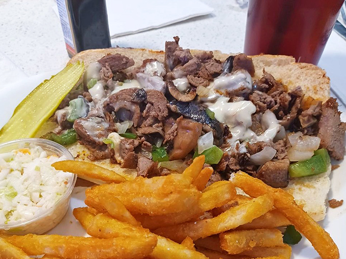 This isn't just a sandwich; it's an engineering marvel of tender beef, melted cheese, and grilled vegetables that requires both hands and several napkins.