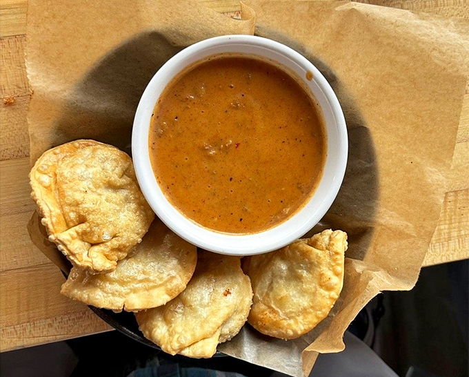 Golden pierogis swimming in rich sauce prove that comfort food knows no borders – just pure, satisfying deliciousness.