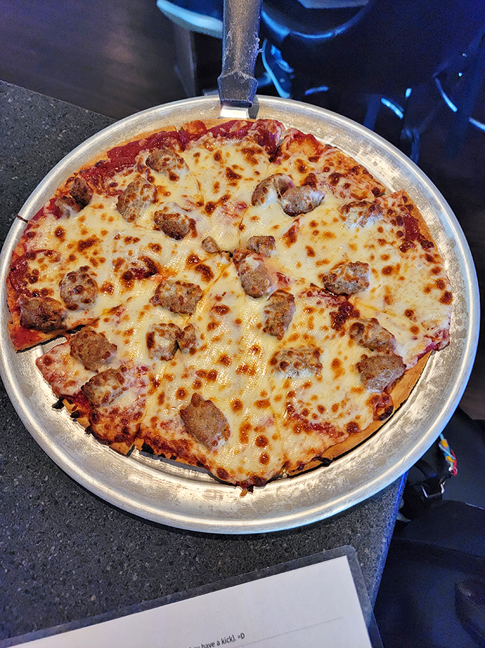 Pizza perfection with sausage islands floating on a sea of melted cheese. The kind of pie that makes you cancel your diet plans with zero regrets.