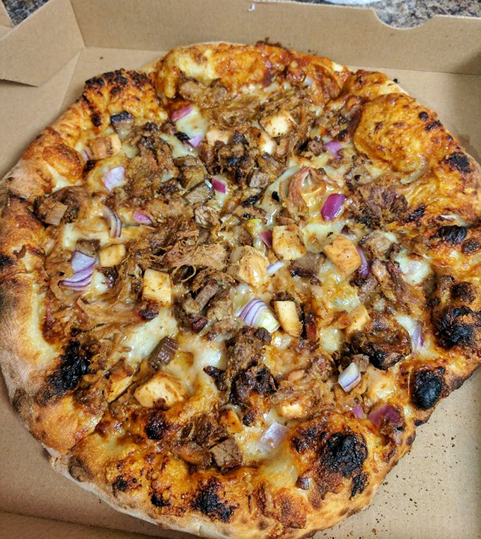 Wood-fired pizza that doesn't play by the rules &ndash; this pie combines smoky, charred perfection with toppings that would make an Italian grandmother both confused and proud.