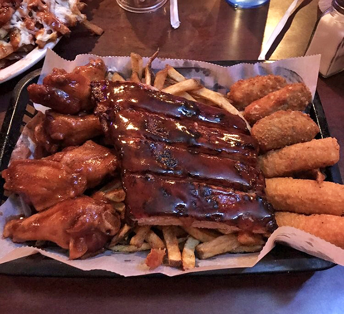 This isn't just a platter&mdash;it's a barbecue United Nations where ribs, wings, and sides have gathered to form a delicious alliance on a bed of fries.