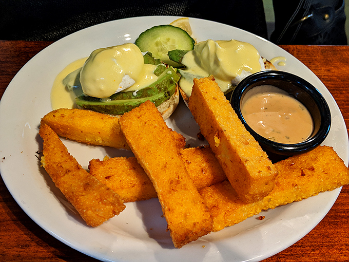 Golden polenta fries stand at attention like delicious soldiers guarding eggs Benedict&mdash;a crispy, creamy textural masterpiece worth crossing state lines for.