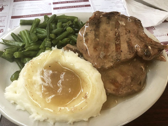 Pork chops swimming in gravy alongside mashed potatoes that could make a carb-counter weep with joy. Worth every delicious calorie.