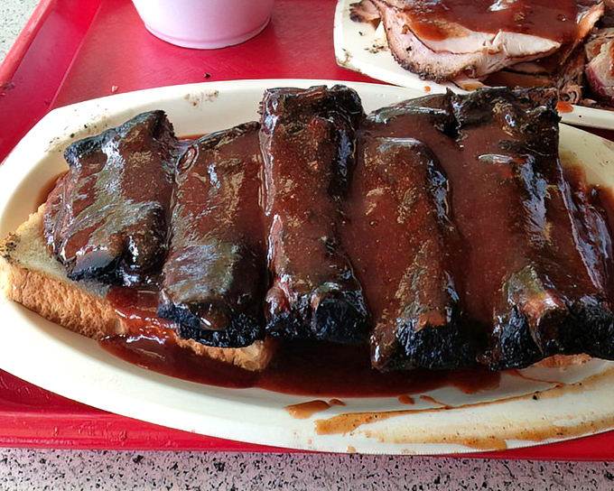 These ribs aren't "falling off the bone"&mdash;they're clinging to it just enough to remind you that proper barbecue has standards.