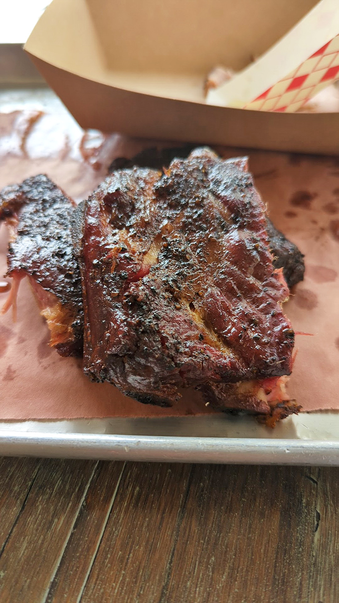 These ribs aren't "falling off the bone"&mdash;they're doing exactly what great ribs should: offering just enough resistance before surrendering their smoky goodness.