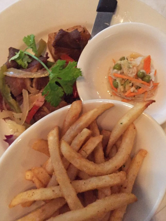 Fork-tender pork shoulder nestled alongside vibrant vegetables and slaw. This is the kind of plate that makes conversation stop while everyone savors the moment.
