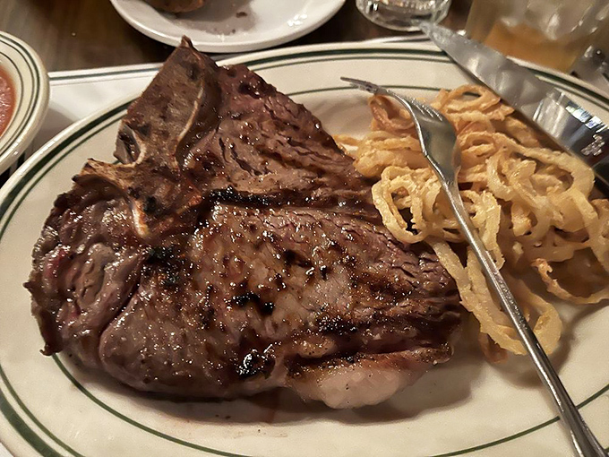 The porterhouse commands respect and real estate on the plate. This isn't a steak; it's a commitment to excellence.